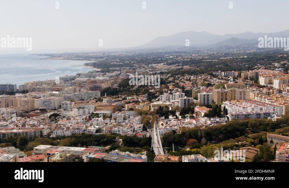 Sliding aerial from right to left over Marbella Spain on spring day ...