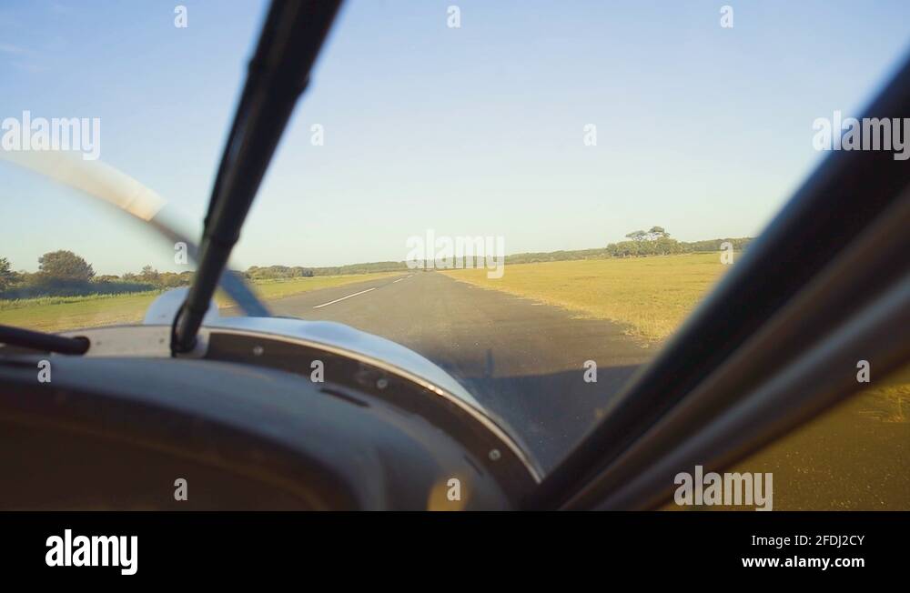 cockpit view in a plane going down the runway about to depart and take ...