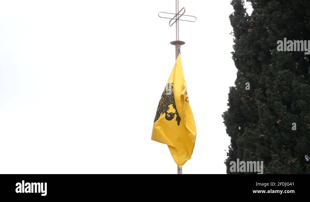Two headed eagle Greek orthodox church emblem flag blowing in breeze ...