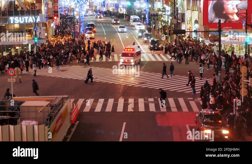Shibuya Crossing, Tokyo, Japan : night time people cross the road at ...