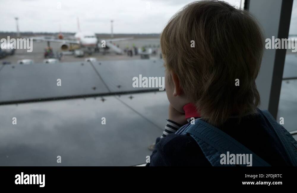 Cute Little Child Watching at Airplanes in Airport Window. Little Boy ...