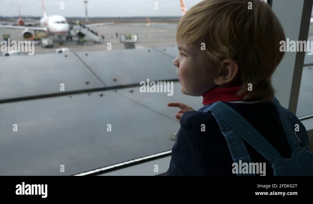 Cute Little Child Watching at Airplanes in Airport Window. Little Boy ...