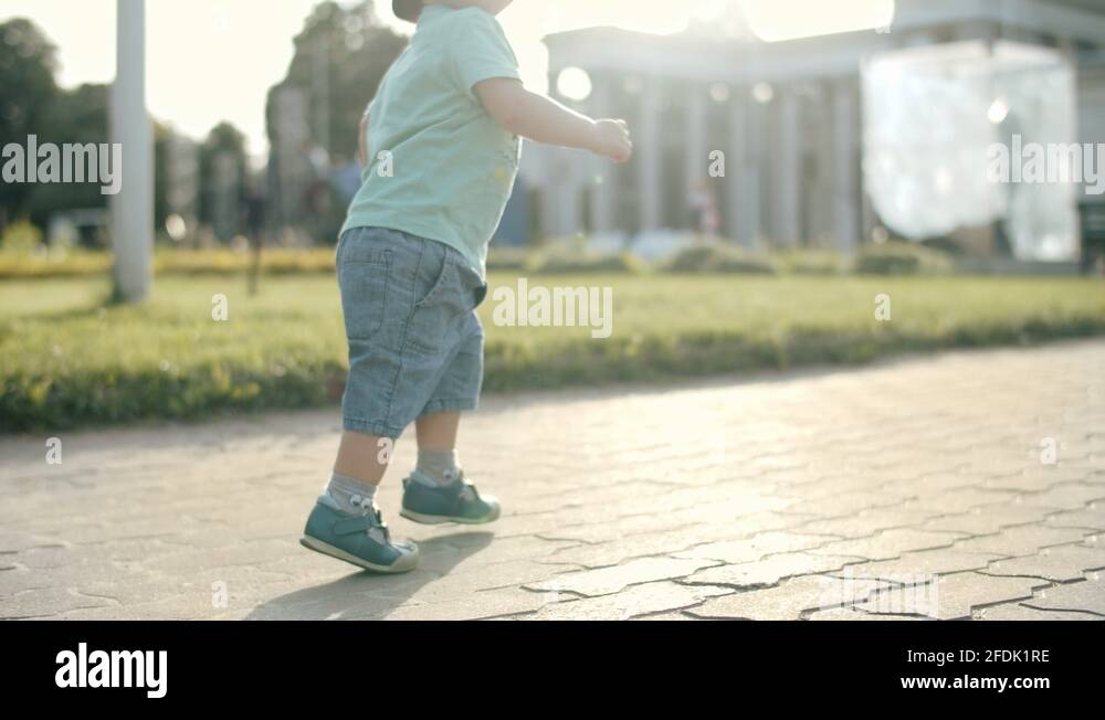 Unrecognized boy running in amusement park. Little kid walking rapidly ...