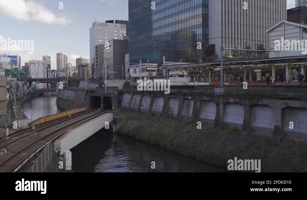 Multiple trains running across train railway platforms in Tokyo, Japan ...