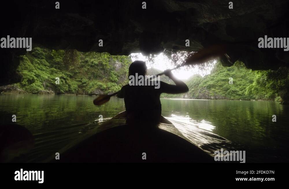 Kayaking through the cave in Vietnam revealing beautiful green ...