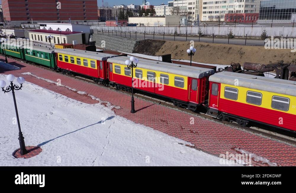 Flight over railway station. Passenger train and narrow-gauge railway ...