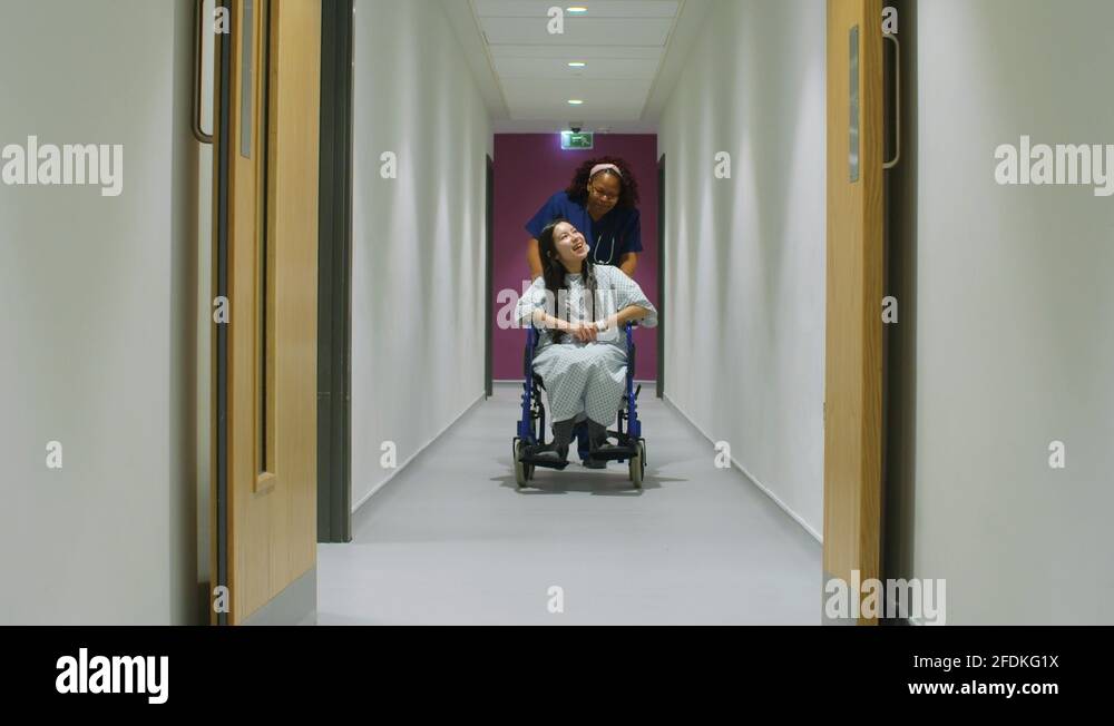 Female Nurse Pushing Happy Patient In Wheelchair Stock Video Footage ...