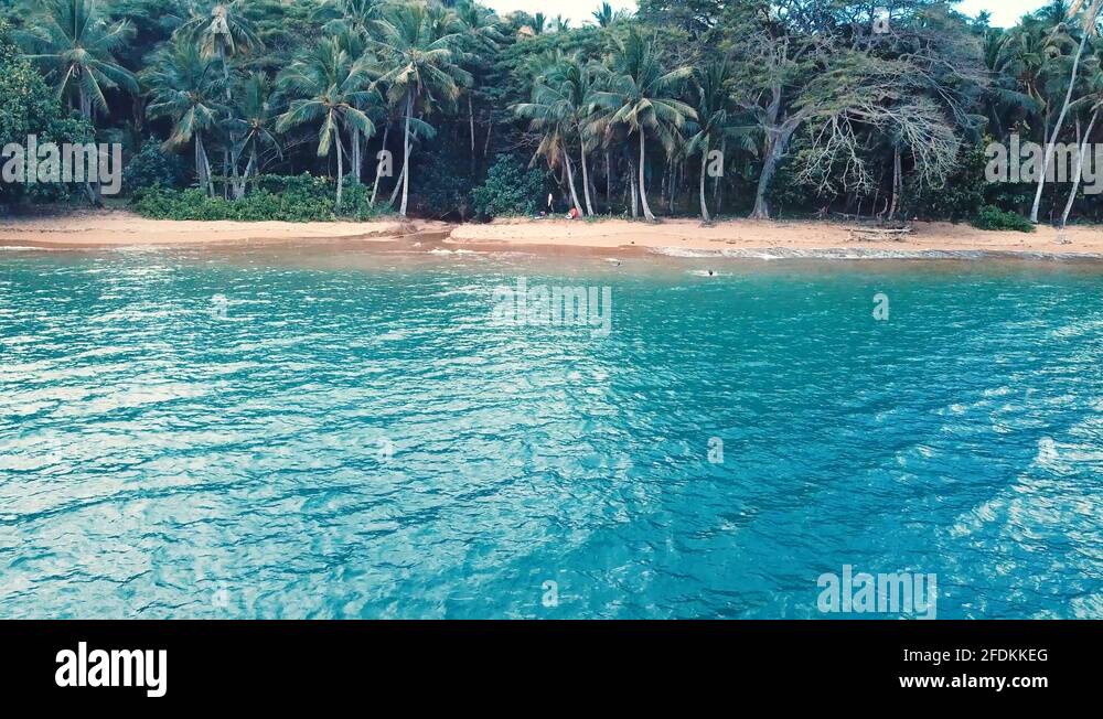 People swimming in a secluded beach with kayaks Stock Video Footage - Alamy
