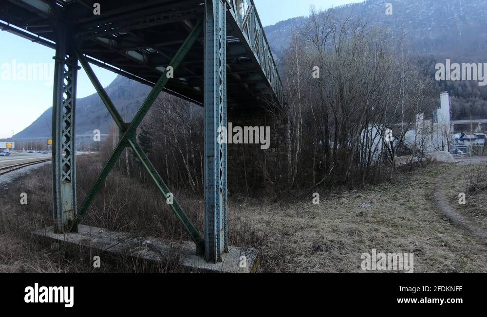 Tilt up view of a green bolted railroad steel bridge support structure ...