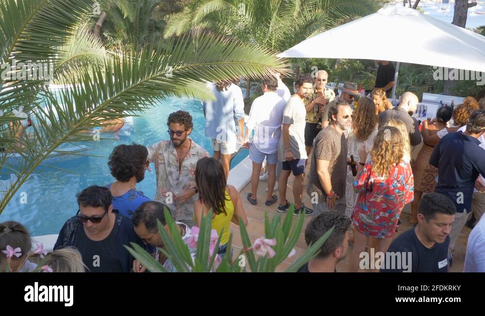 Villa party by a swimming pool in Ibiza with a lot of people enjoying ...