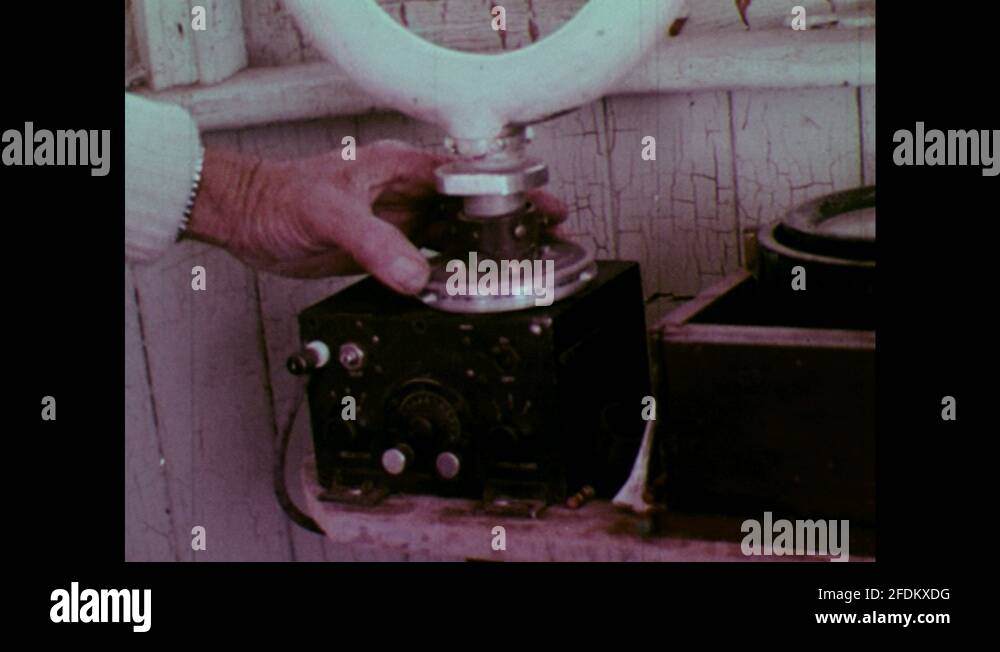 1960s: Captain of ship uses tools to chart course. Man moves boat's ...