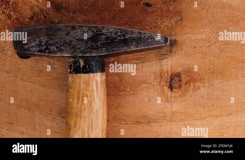 Worn hammer with falling nails on wooden work bench. Close UP. Concept ...