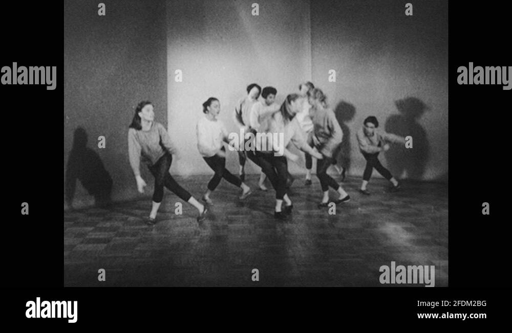 1950s: Group of girls dancing in studio, dancers enter, pose in ...