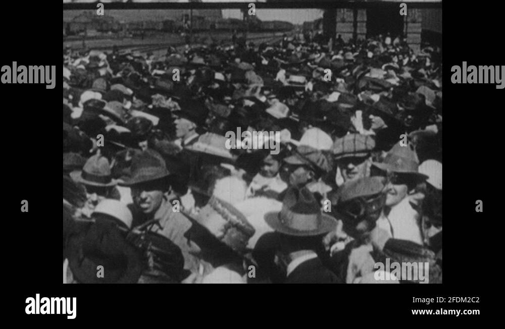 1950s: Crowd of people. President Wilson shakes man's hand. Cars drive ...
