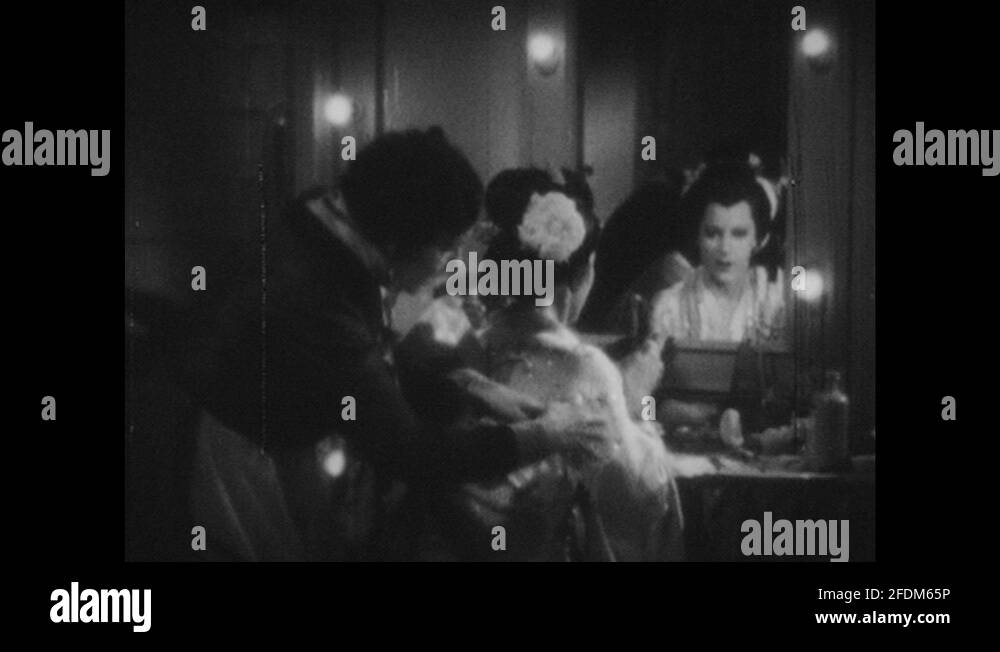 1940s: Opera singer sits at a vanity in a dressing room. Opera singer ...