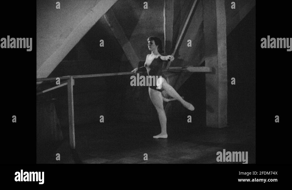 1950s: Girl dancing at ballet barre, twirling. Girl dancing in studio ...