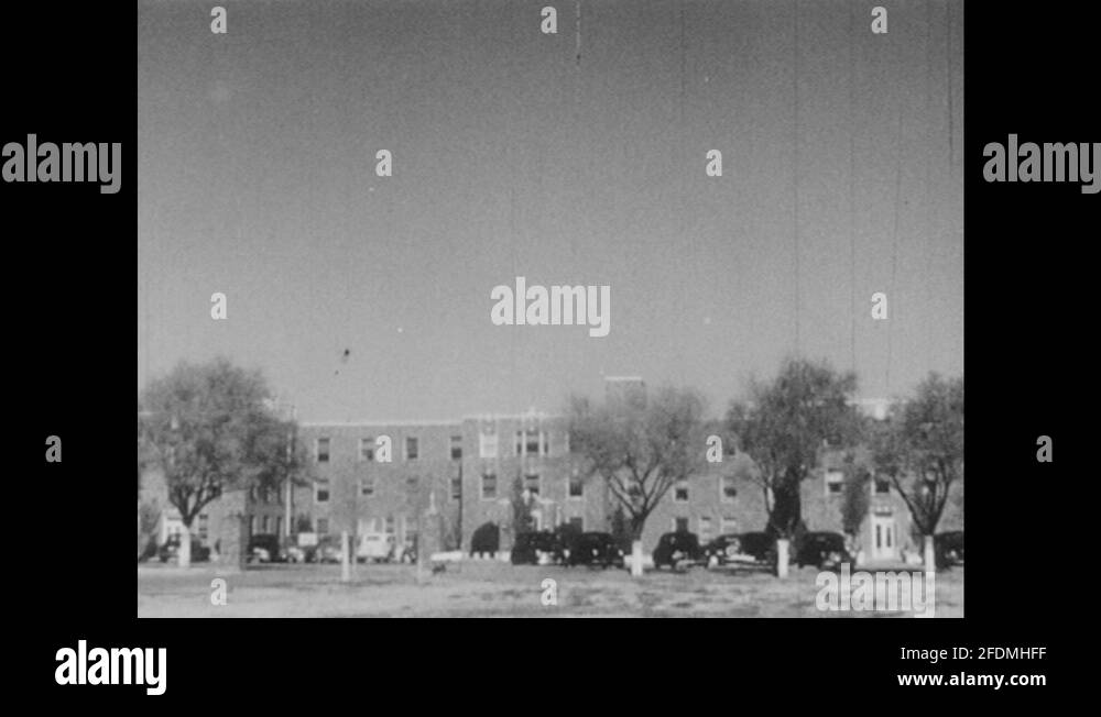 1960s: UNITED STATES: community hospital building. Man visits hospital ...