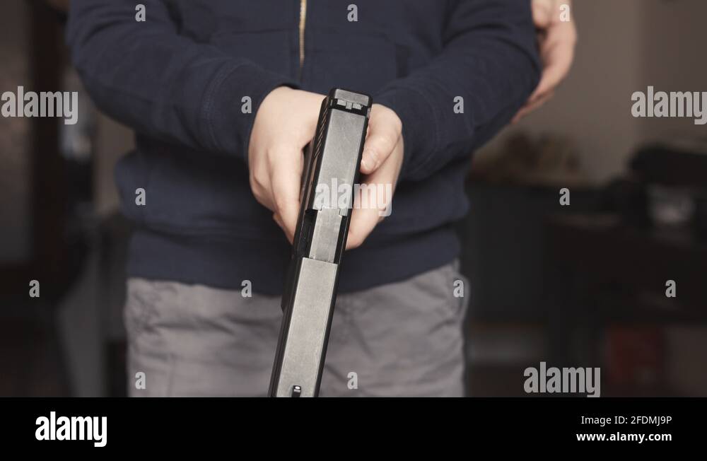 Father teaching to his son how to load a nine millimeter toy gun ...