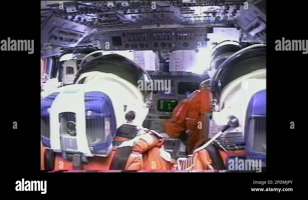 1990s: Rear view of astronauts seated in space shuttle Stock Video ...