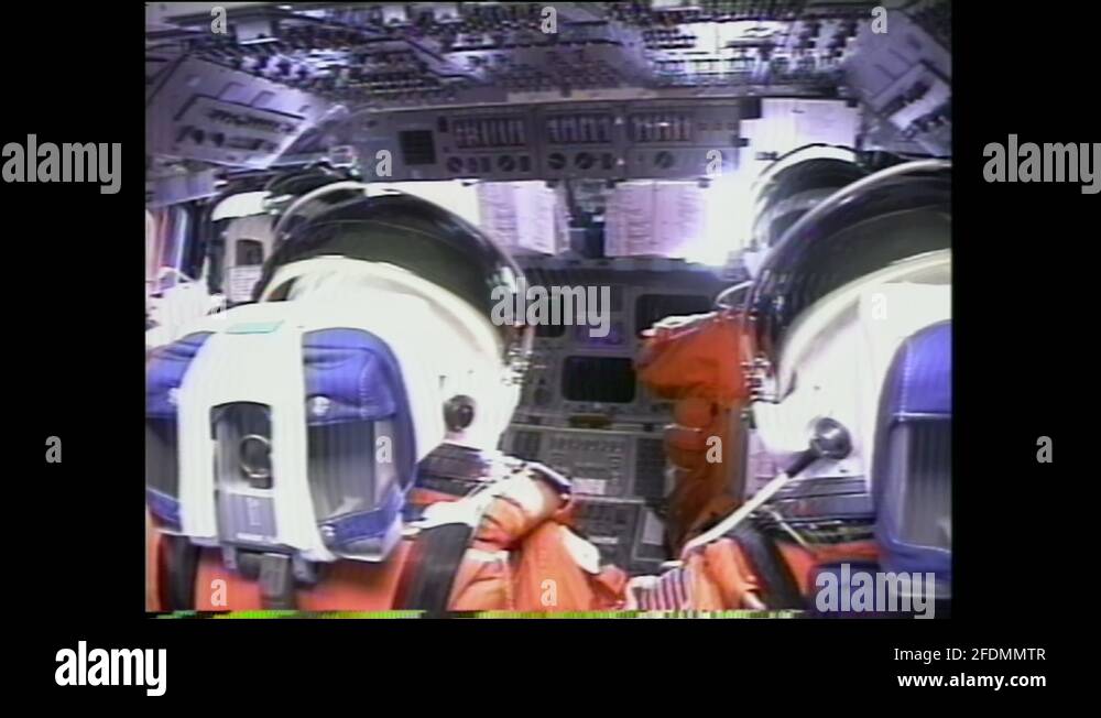 1990s: Rear view of astronauts seated in space shuttle Stock Video ...