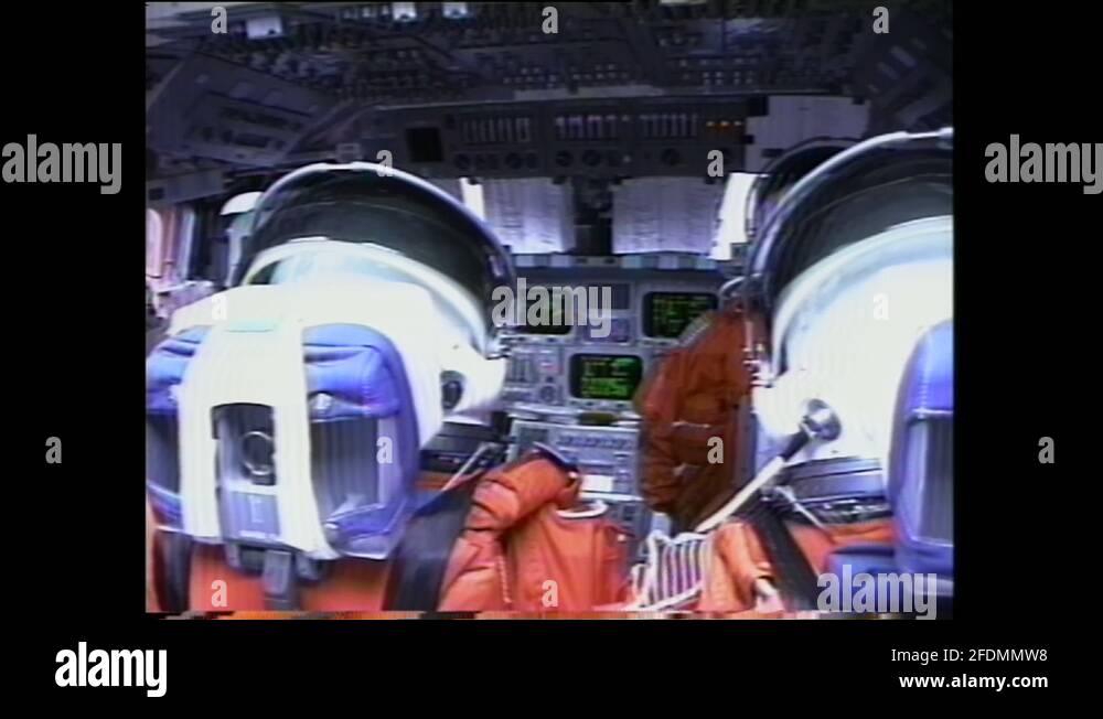 1990s: Rear view of astronauts seated in space shuttle Stock Video ...