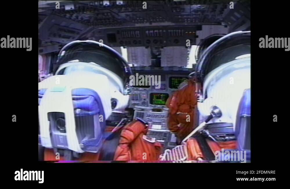 1990s: Rear view of astronauts seated in space shuttle Stock Video ...