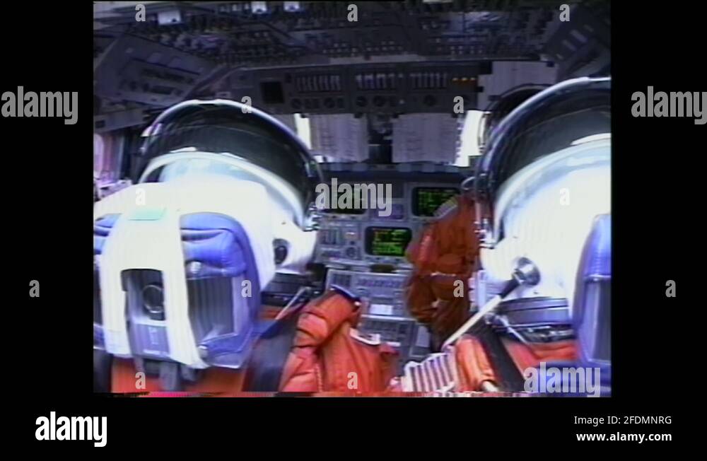 1990s: Rear view of astronauts seated in space shuttle Stock Video ...