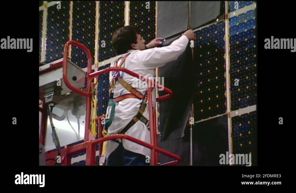 1990s: Man works on solar array panel. Astronaut works inside ...