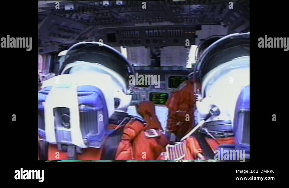 1990s: Rear view of astronauts seated in space shuttle Stock Video ...