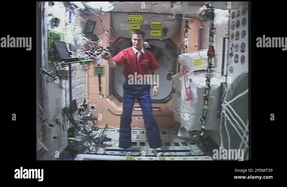 1990s: Astronaut plays with astro jacks toy in zero gravity. Man swings ...