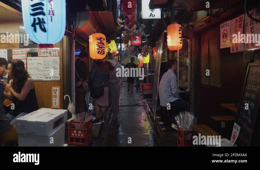 a very small and narrow alley in Shinjuku, Tokyo, Japan at a rainy ...