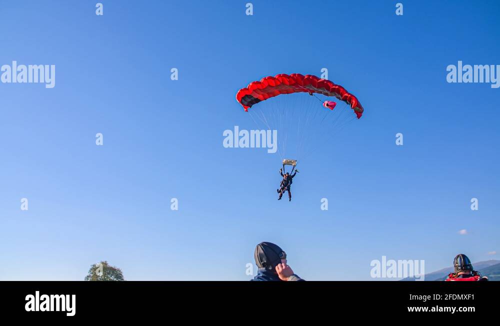 Tandem Skydivers Successfully Land Safely On The Ground By Parachute ...