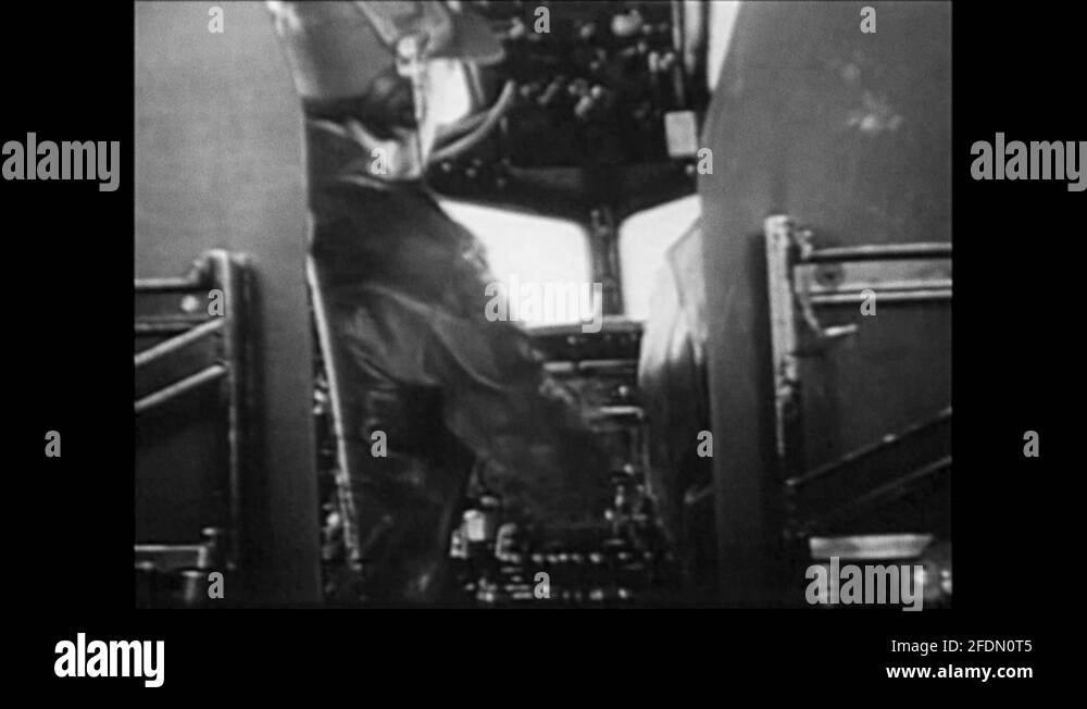 1960s: Pilots in cockpit. Shipyard. Men load cargo into hold. Airplane ...
