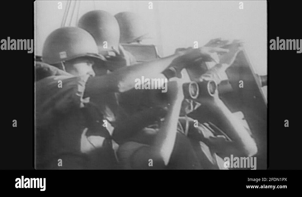 1940s: Guns firing on ship. Soldiers on ship. Pan of plane flying. Ship ...