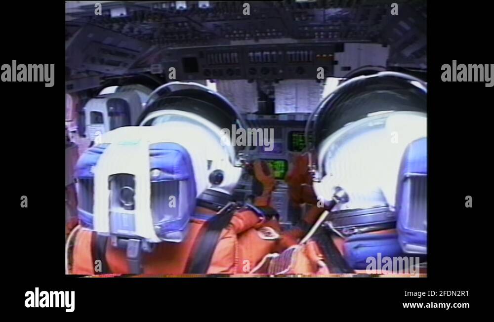 1990s: Rear view of astronauts seated in space shuttle, astronauts free ...