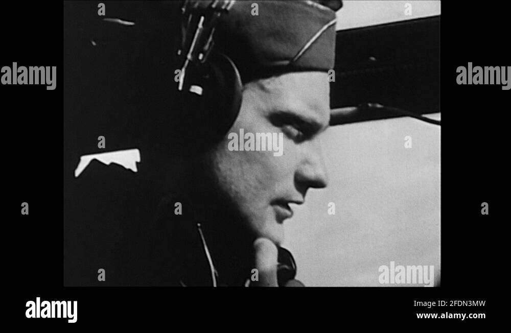 1940s: pilot in cockpit talks, puts on oxygen mask, military plane with ...