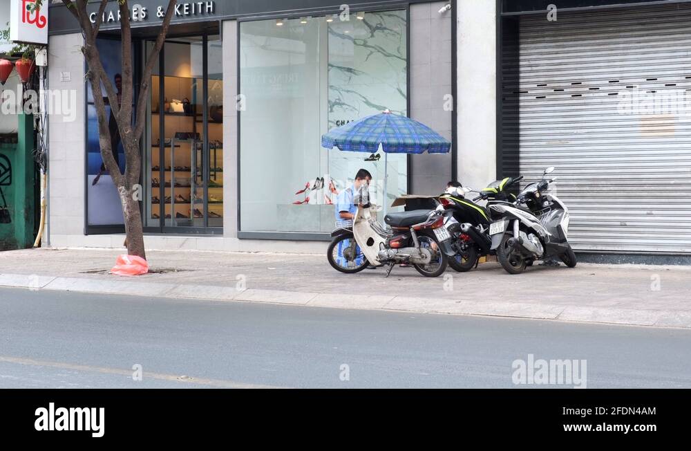 Security Guard Typing On His Phone While On Work Break. Street Scene In ...