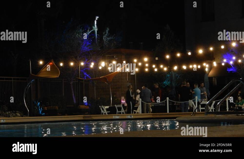 People Celebrating At An Outdoor Pool Gathering At Night Luxury Resort ...