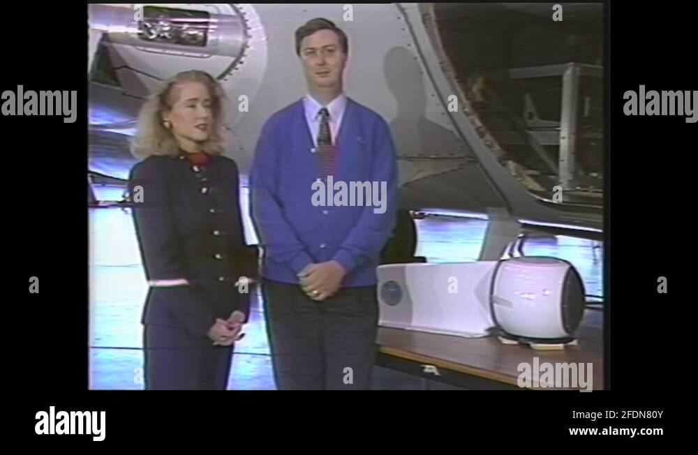 1990s: Man and woman stand by a doppler lidar system and speak. Man ...
