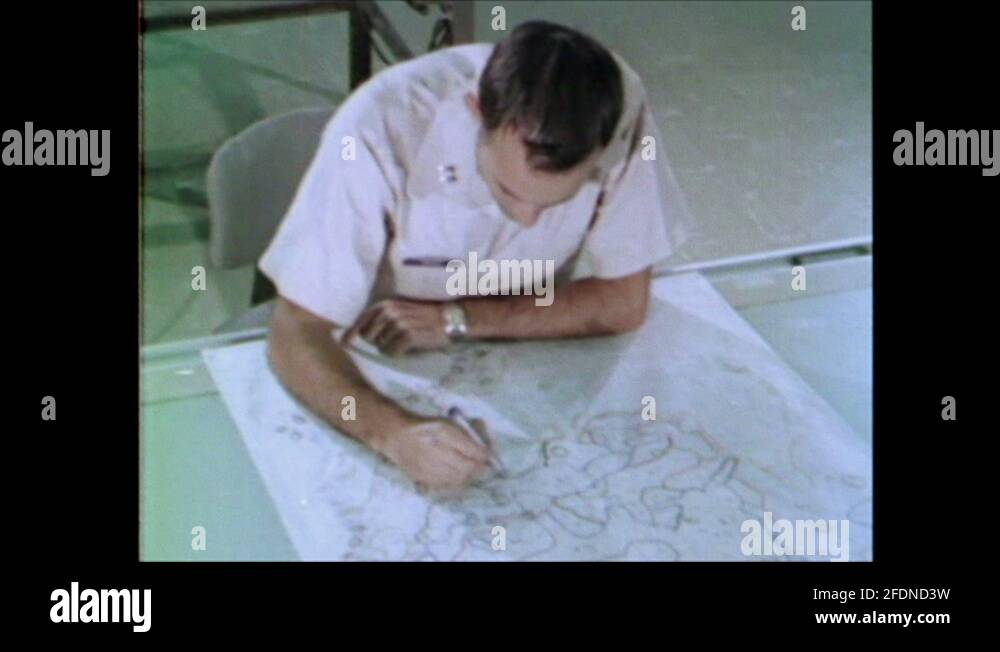 1970s: soldier at desk uses marker to draw on map, map of weather ...