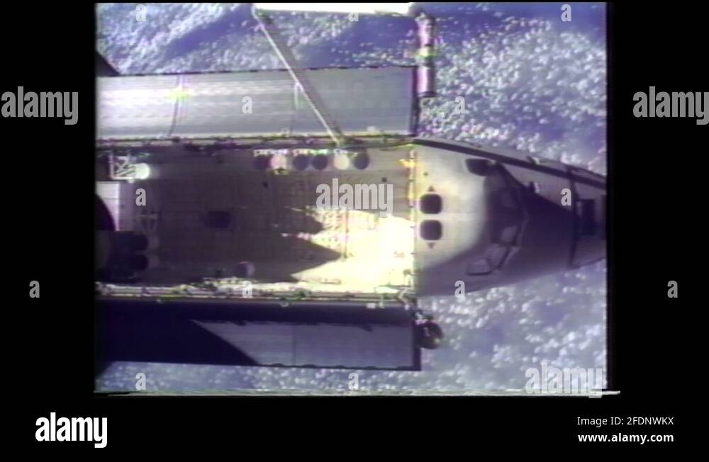 1990s: Space Shuttle in orbit with cargo bay open. Solar panel is ...