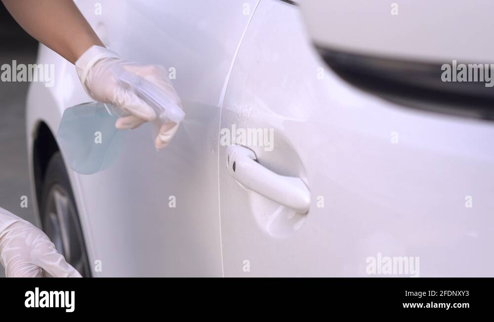 White glove hand spraying and wiping car door handle, car sanitize, 4k ...