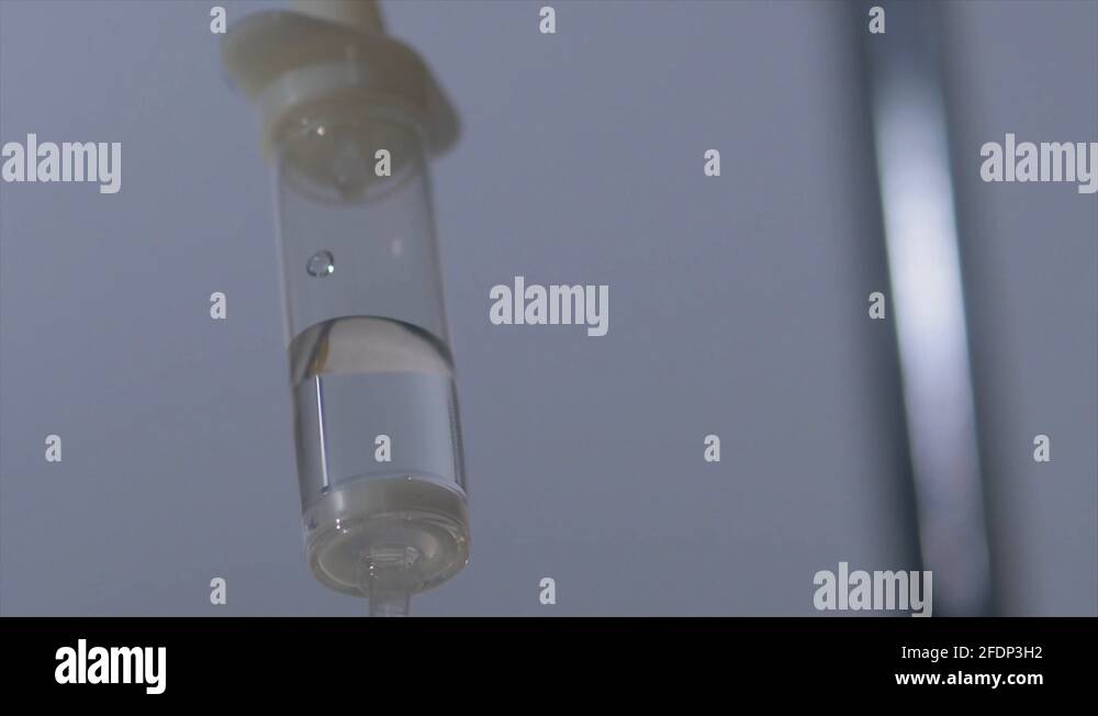 Intravenous drip infusion. Every drop of saline dripping inside syringe ...
