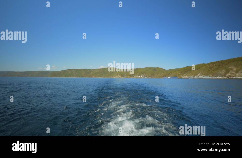 Tilt Down: Slow Moving Boat Travelling Through the Lake Happily Slowly ...