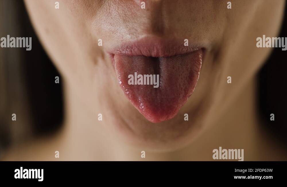 Close Up Of A Girls Mouth As She Playfully Sticks Her Tongue Out At