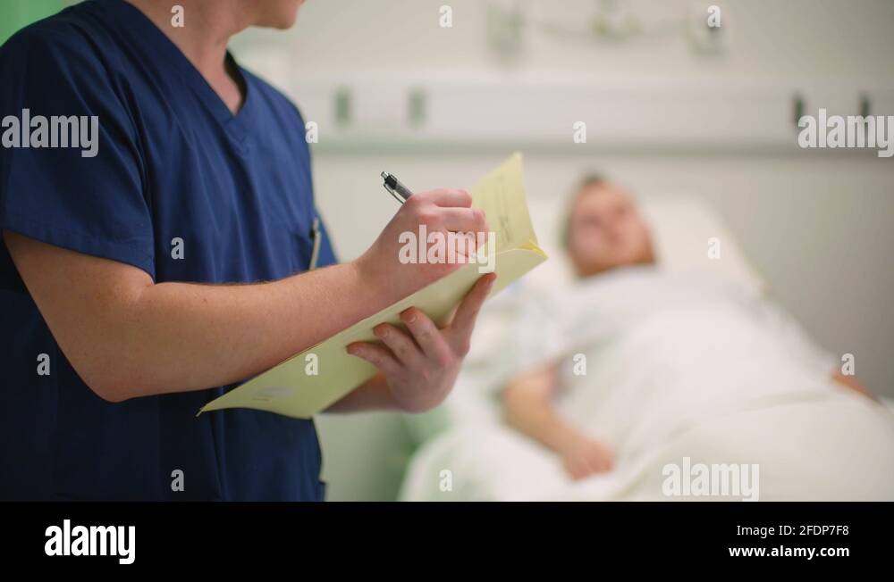 CU Male Nurse Making Notes on Chart Stock Video Footage - Alamy