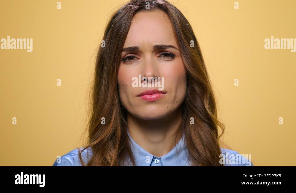Beautiful woman yawning on yellow background. Sleepy girl waking up at ...