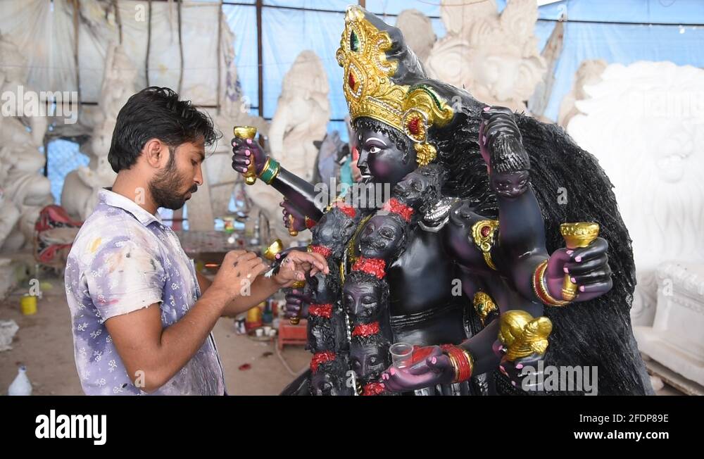 Artist making sculptures & finishing on an idol of the Hindu goddess ...
