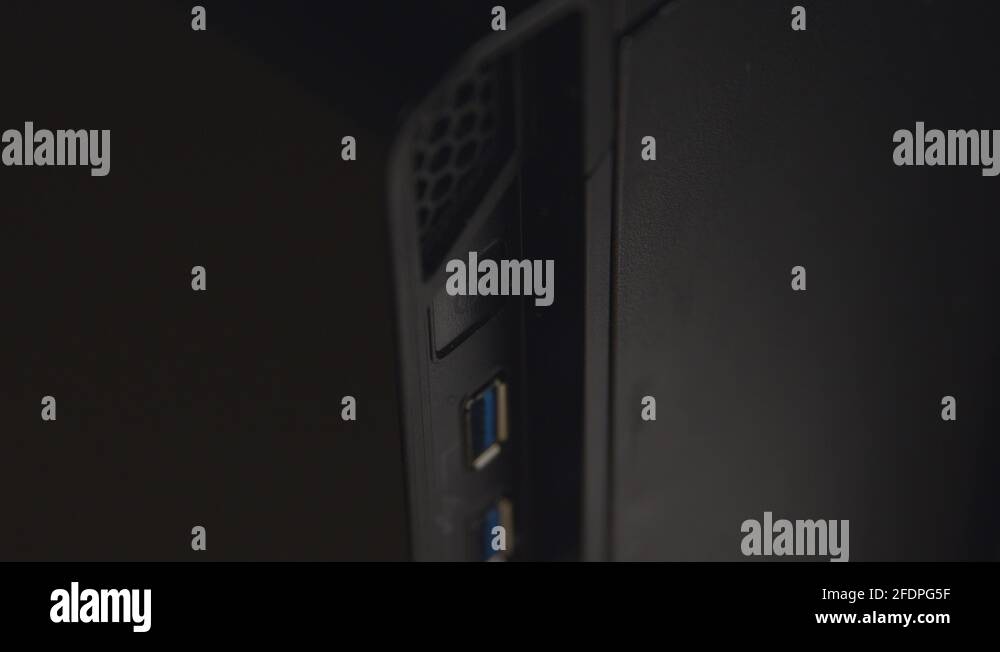 Slowly turning on a desktop computer switch lights up blue Stock Video ...