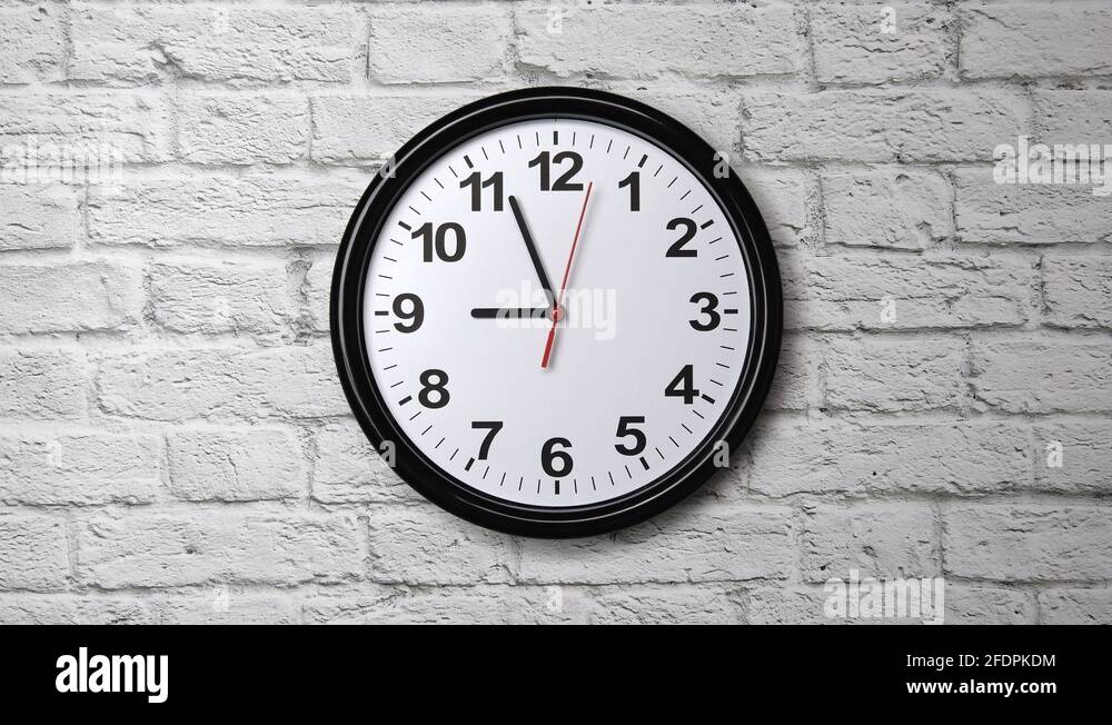 The Time On The Clock Nine. Clock With The Black Arrows And Red Second ...